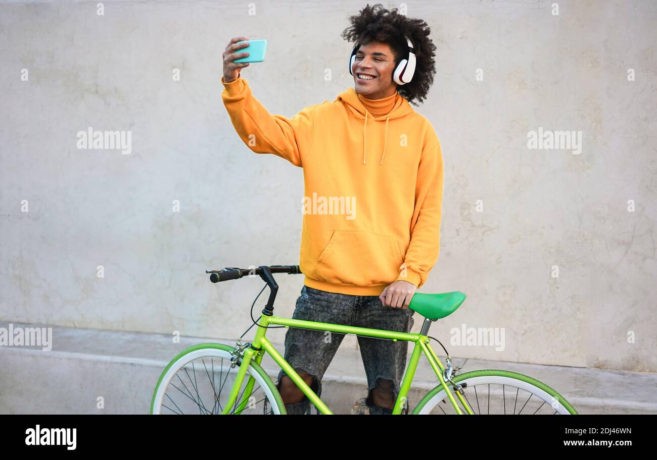 Young millennial african guy making video call on mobile phone outdoors ...