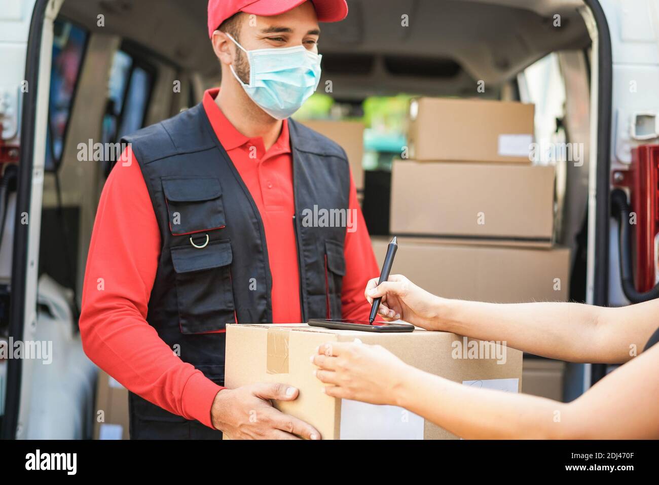 Young woman appending digital signature for shipping delivery - Focus ...