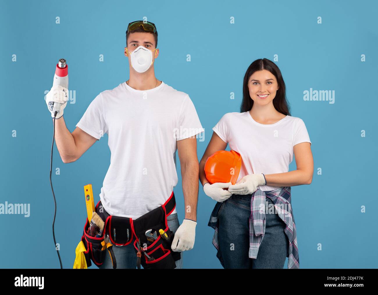 Home Repairment. Young Couple With Construction Tools Posing Over Blue ...
