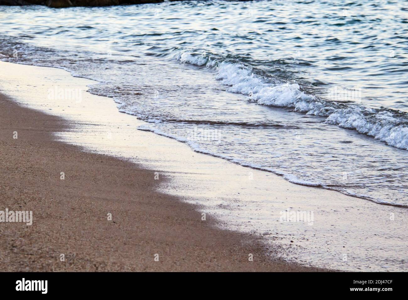 The beach with sea waves running on the sand. Beautiful view on the ...