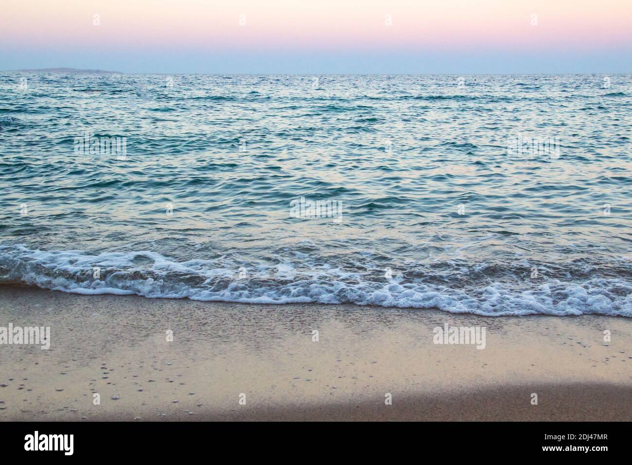 The beach with sea waves running on the sand. Beautiful view on the ...