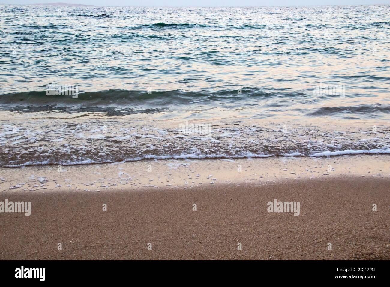 The beach with sea waves running on the sand. Beautiful view on the ...