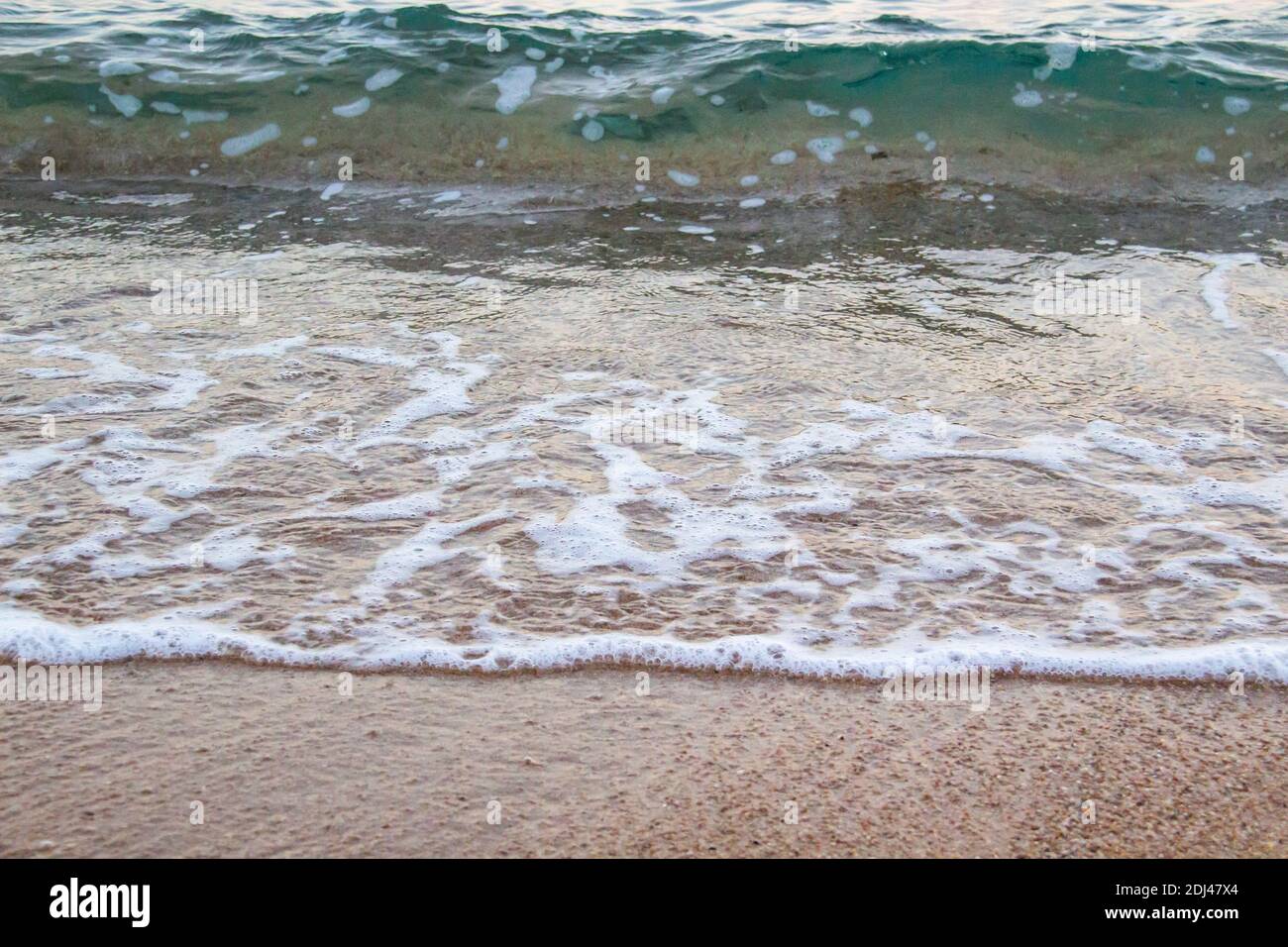 The beach with sea waves running on the sand. Beautiful view on the ...