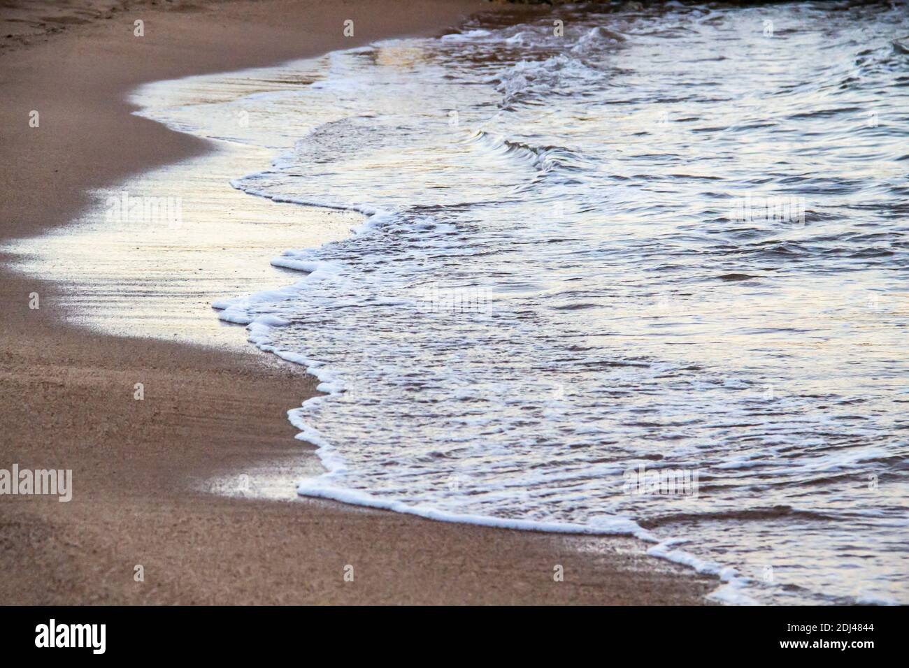 The beach with sea waves running on the sand. Beautiful view on the ...