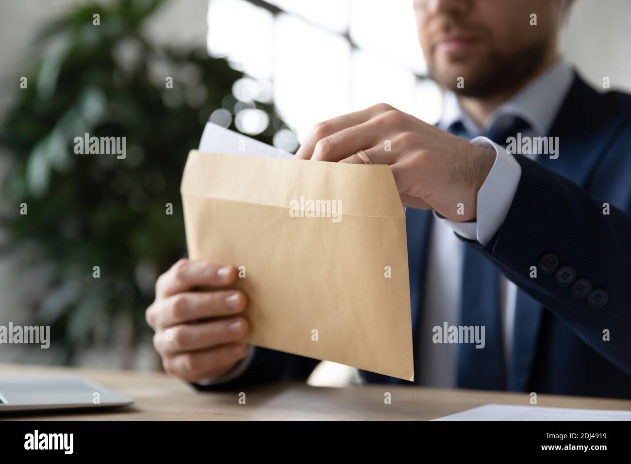 Close up businessman opening paper envelope with letter in office Stock ...