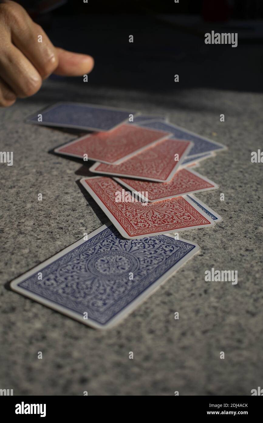 Red and blue playing cards on a marble table Stock Photo - Alamy