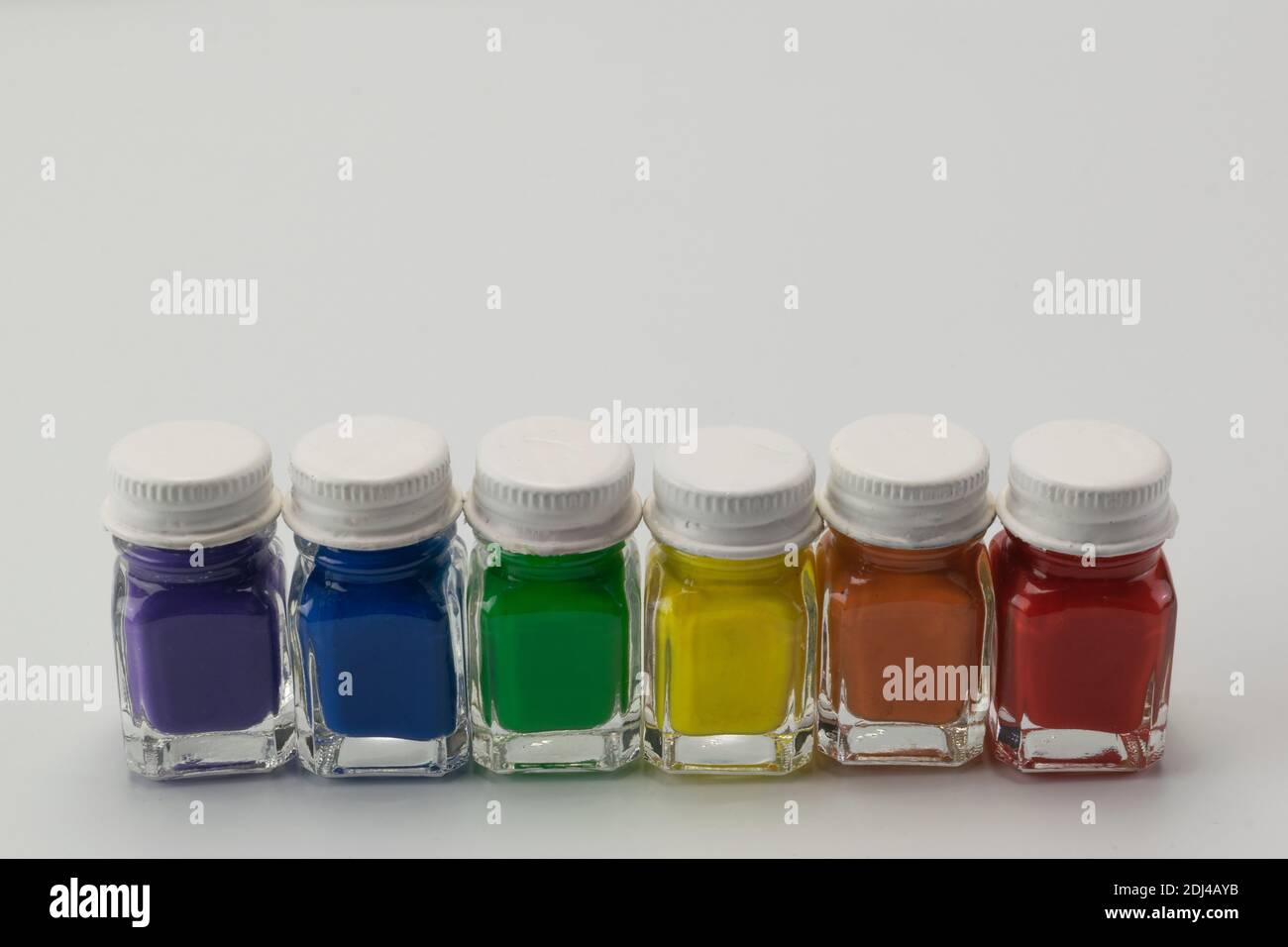 Six glass jars with paint with the colors diversity Stock Photo - Alamy