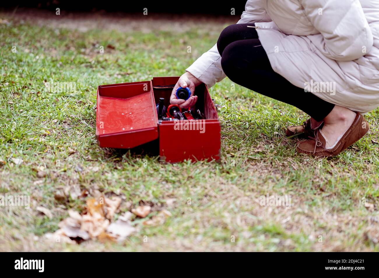 A closeup shot of a female grabbing tools from a toolbox Stock Photo ...