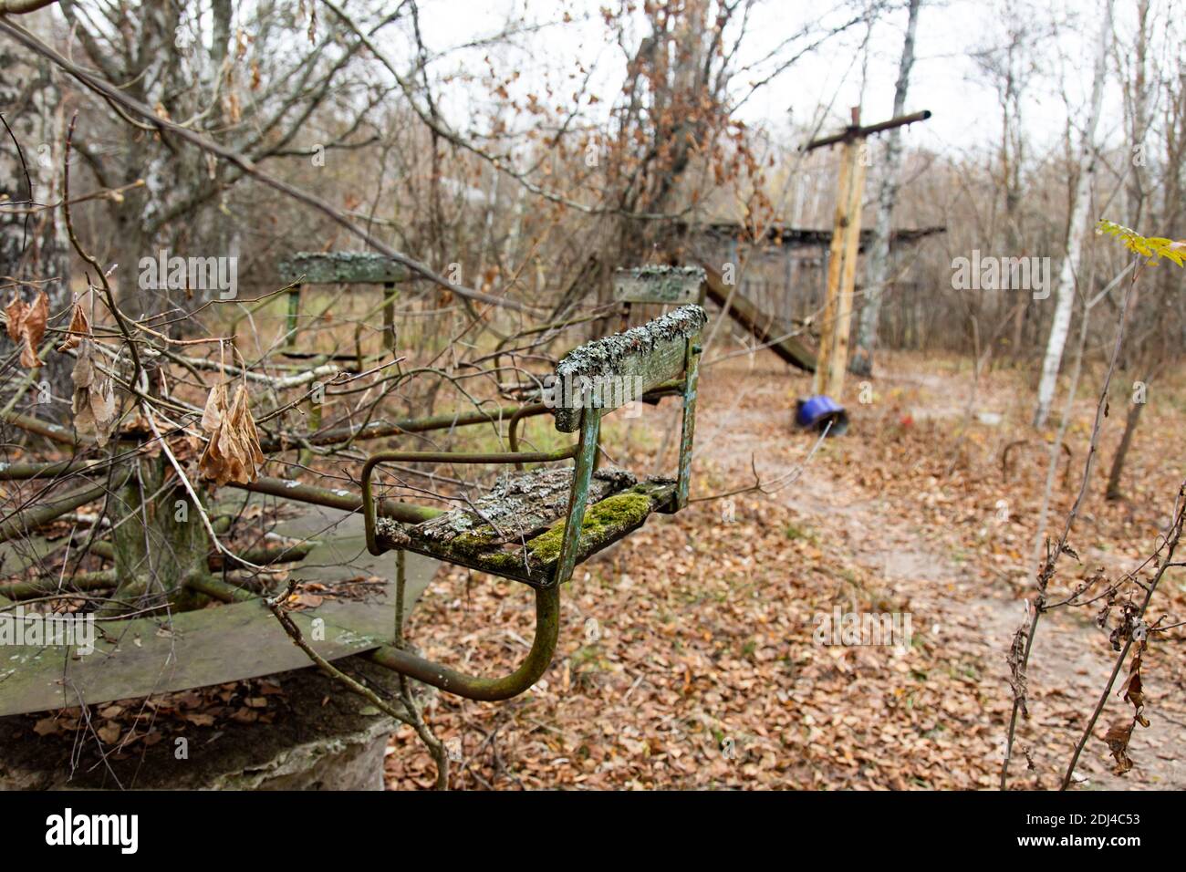 Scary and abandoned carousel in playground of a village near Pripyat, a ...