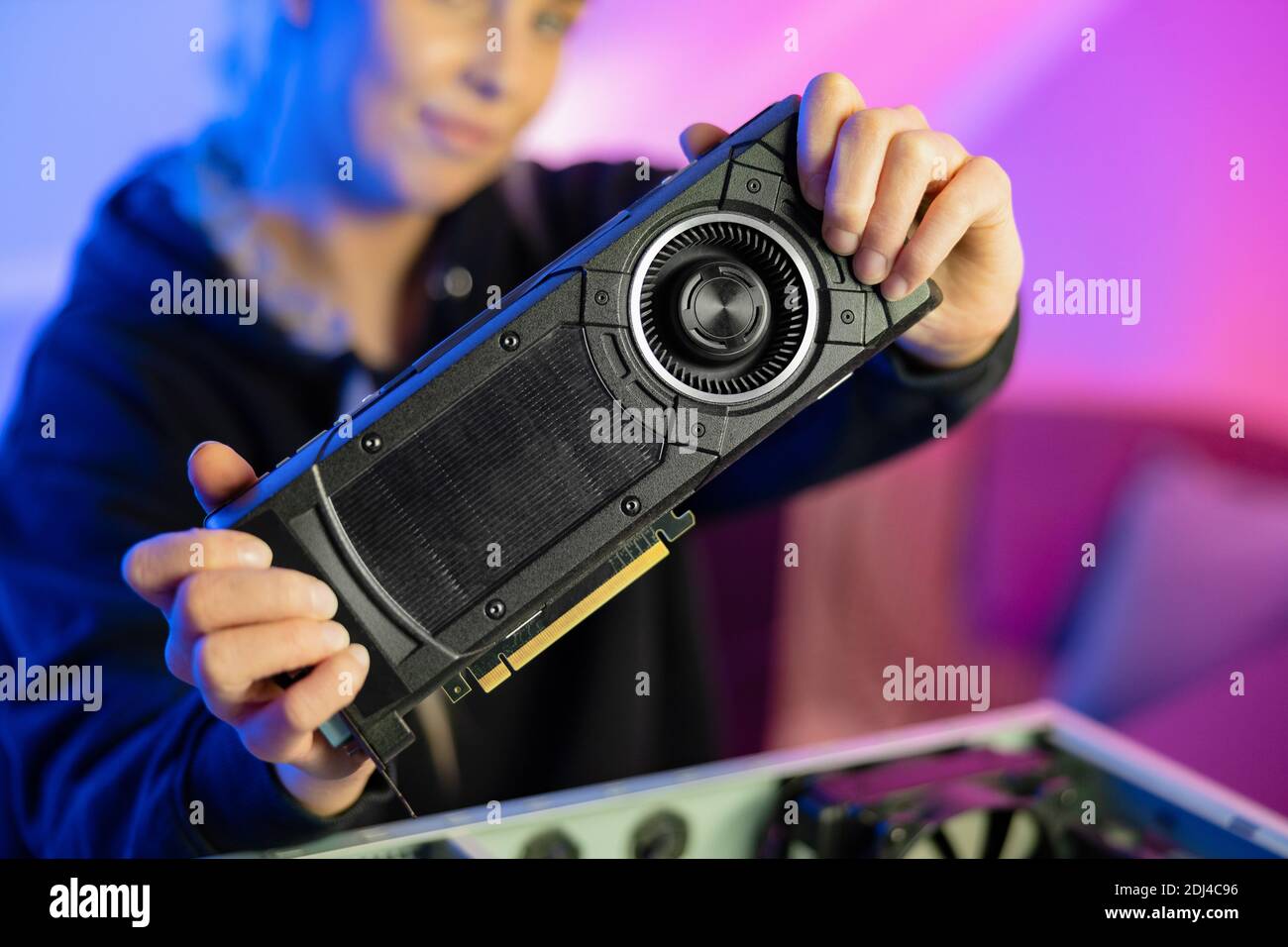 Gamer Girl Holding a New GPU Video Card in Her Hands Stock Photo - Alamy