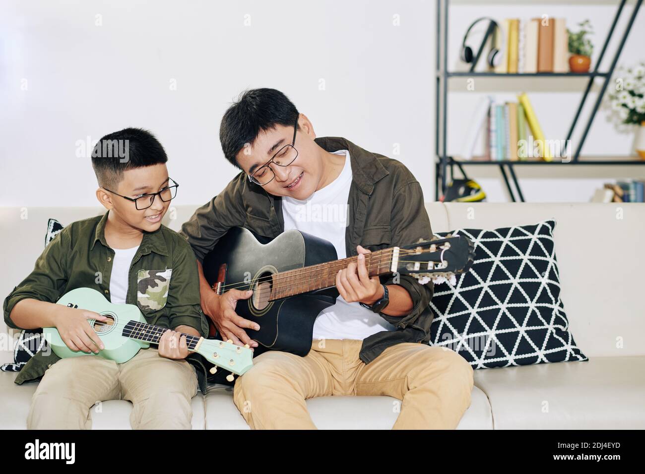 Father and son playing new song Stock Photo - Alamy