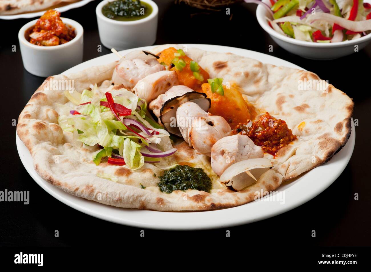 Indian Ethnical Food Chicken tikka masala on Naan Bread Stock Photo - Alamy