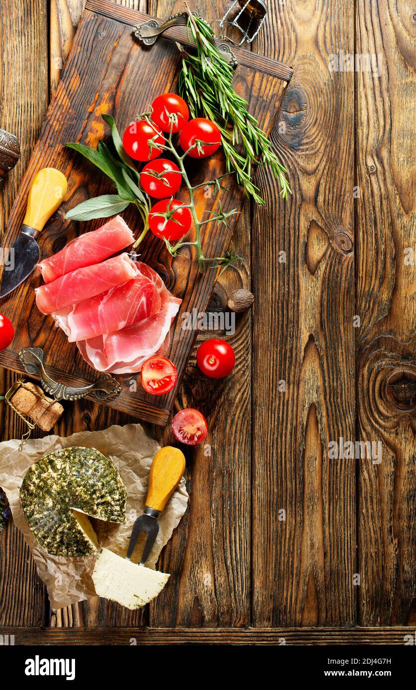 Sliced jamon on cutting board with cheese Stock Photo - Alamy