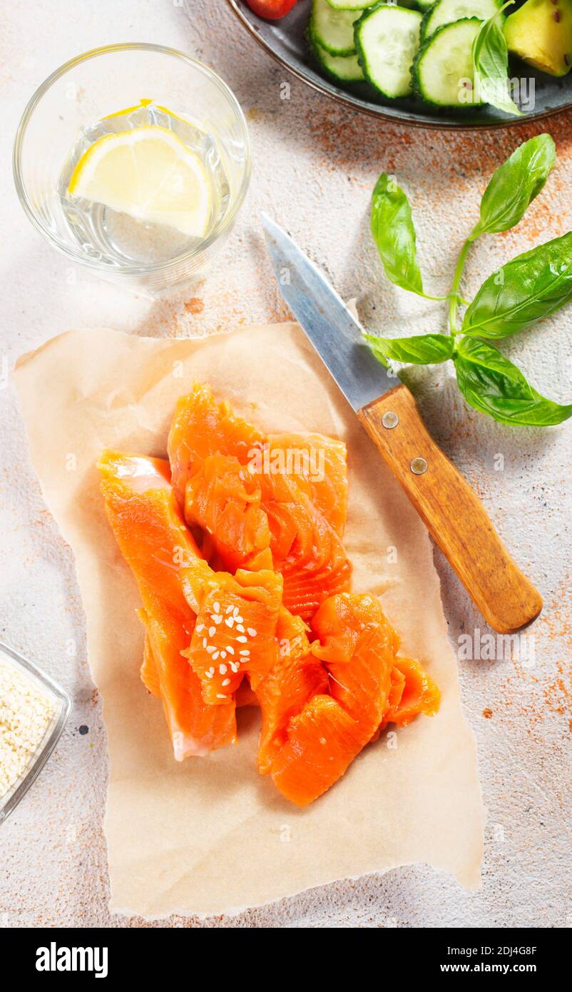 raw salmon, sashimi with vegetables on paper Stock Photo - Alamy