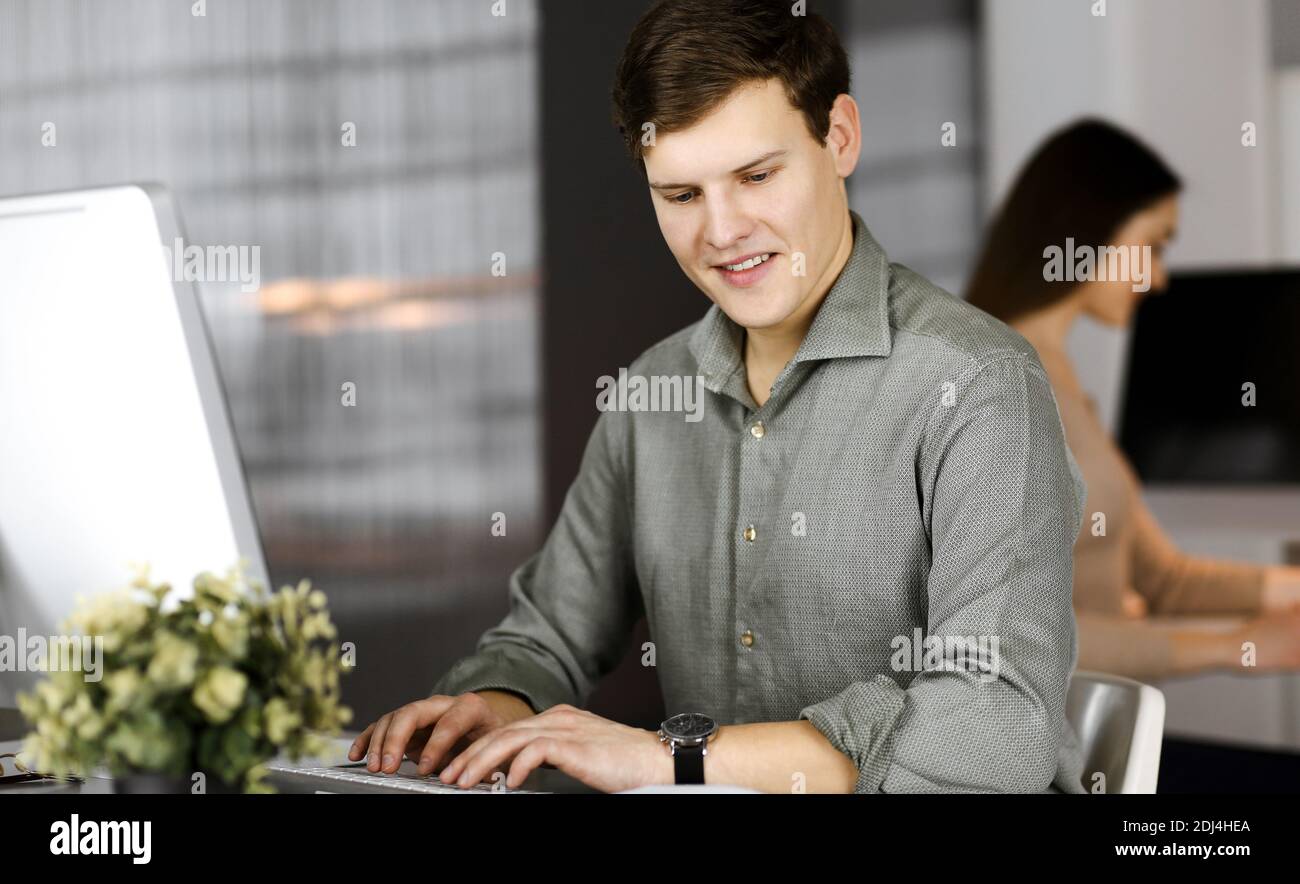 Hard-working young businessman in a green shirt is searching for some ...