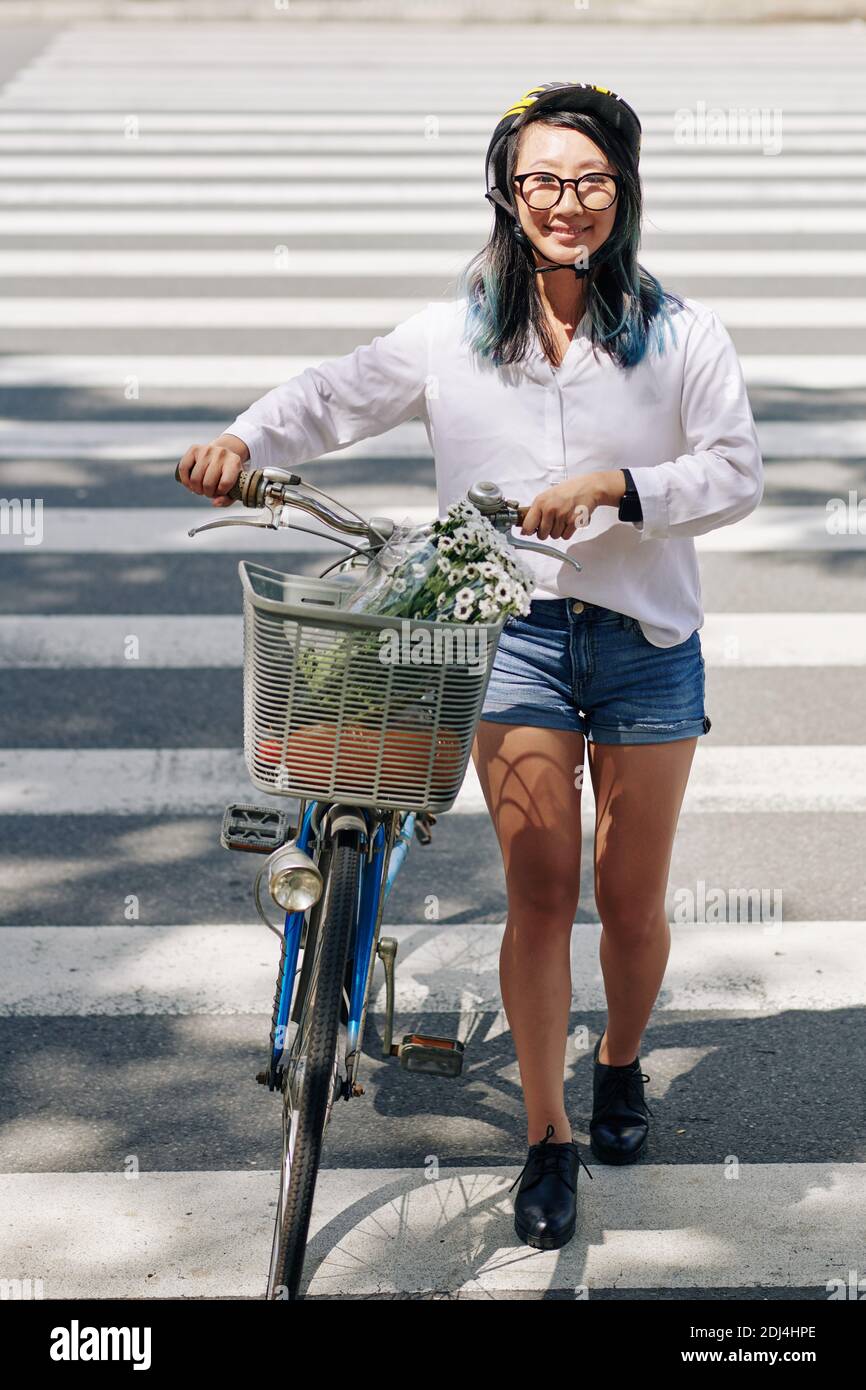 Female cyclist crossing road Stock Photo - Alamy