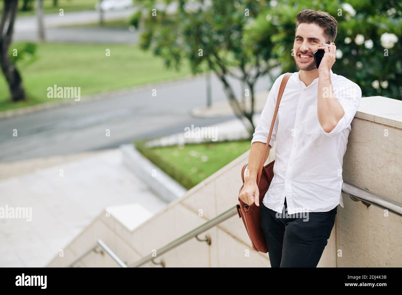 Young man answering the phone call Stock Photo - Alamy