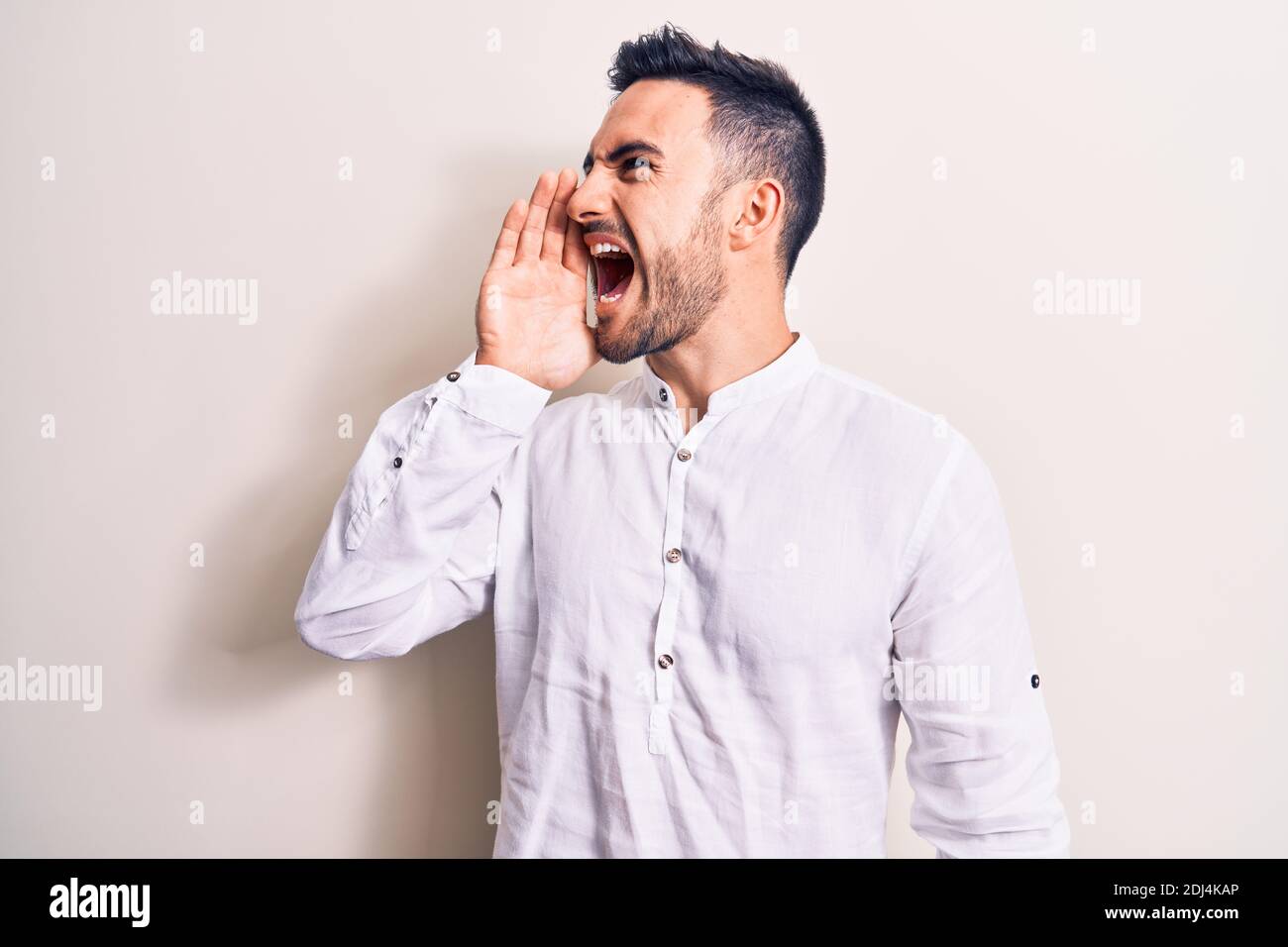 Young handsome man with beard wearing casual t-shirt standing over ...