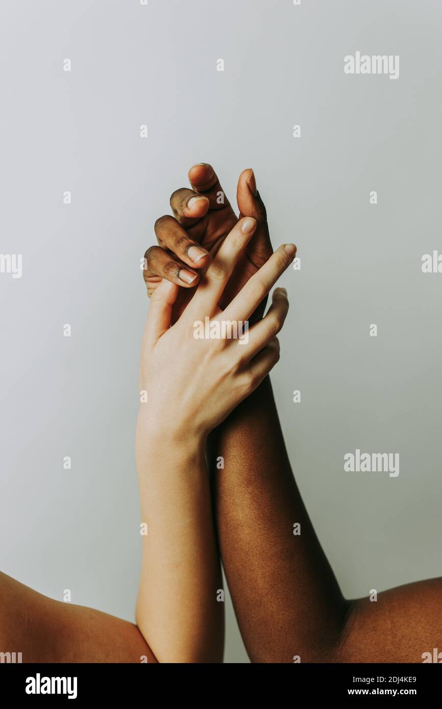 Arms of black and white women, concepts about racial integration, human ...