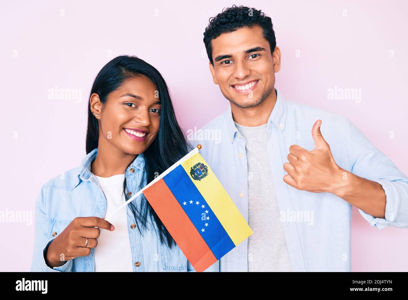 Beautiful latin young couple holding venezuelan flag smiling happy and ...