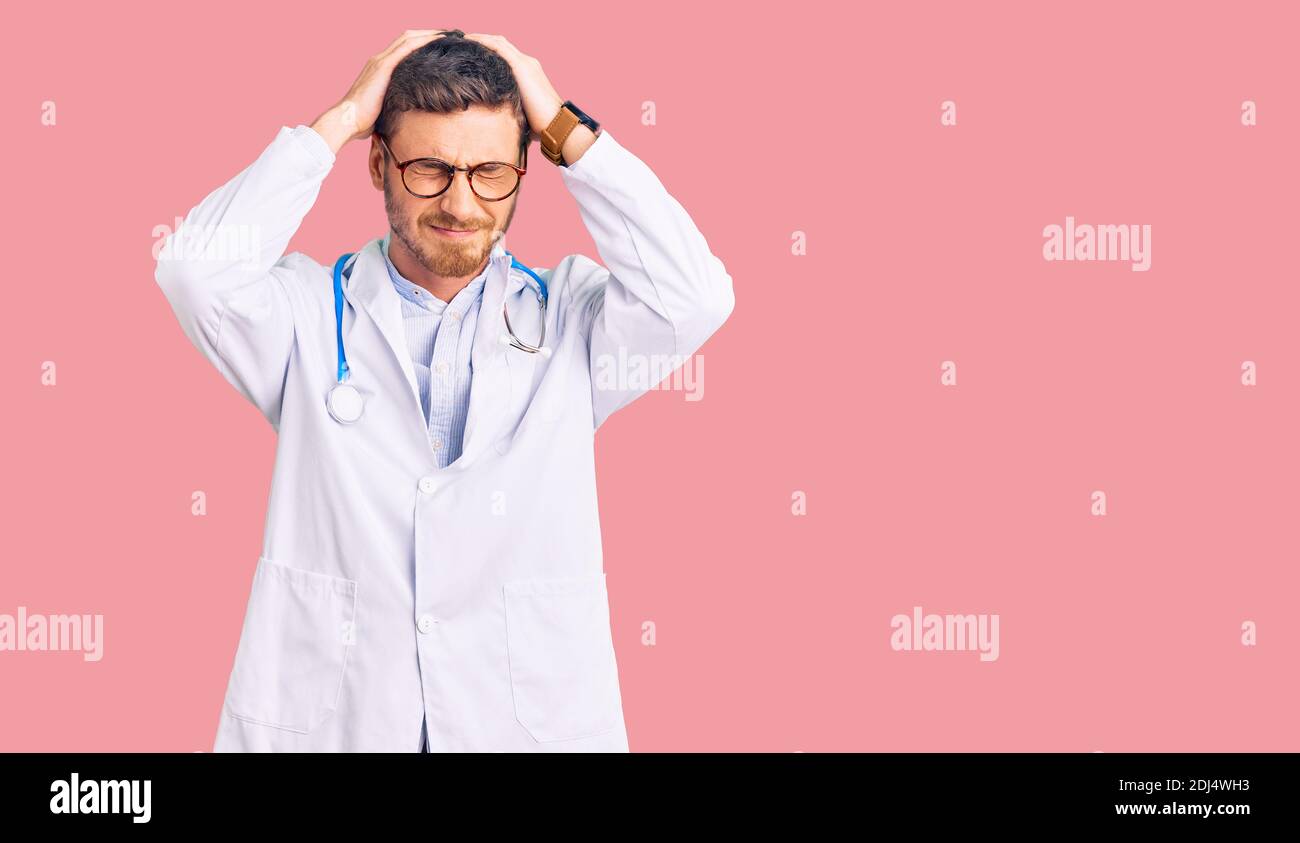 Handsome young man with bear wearing doctor uniform suffering from ...