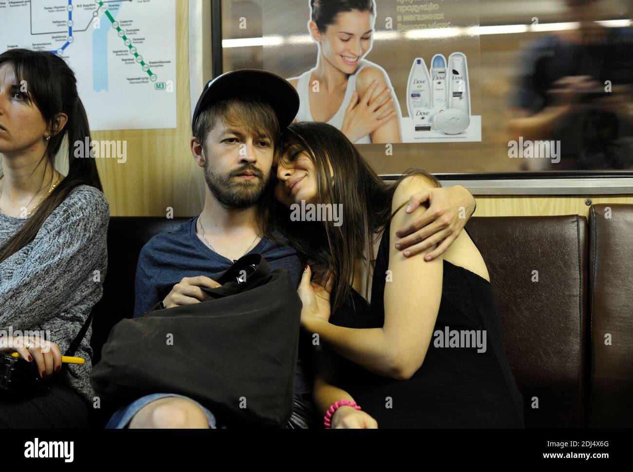 Smiling happy girl putting her head on her boy's shoulder sitting in a ...