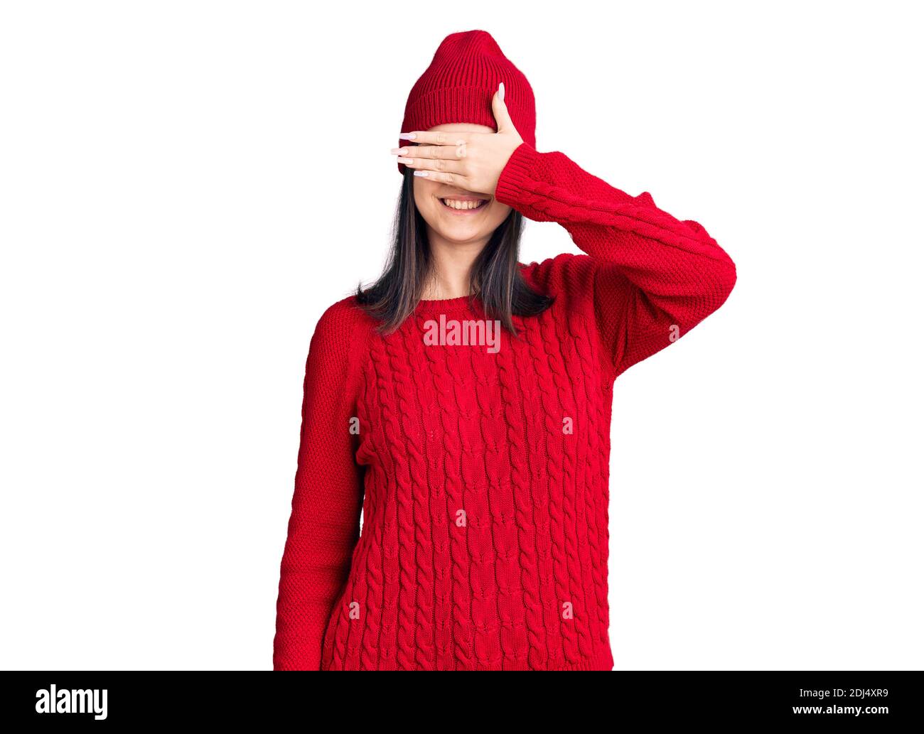Young beautiful girl wearing sweater and wool cap smiling and laughing ...