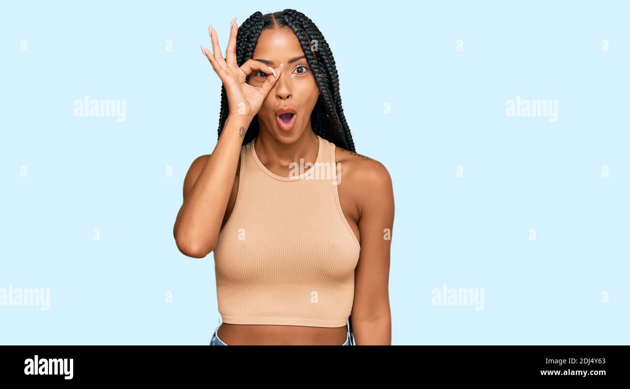 Beautiful hispanic woman wearing casual clothes doing ok gesture ...