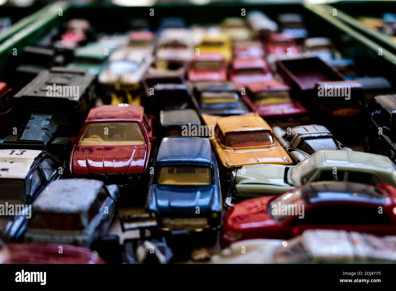 A closeup of vintage car toys creating a traffic jam with a blurry ...