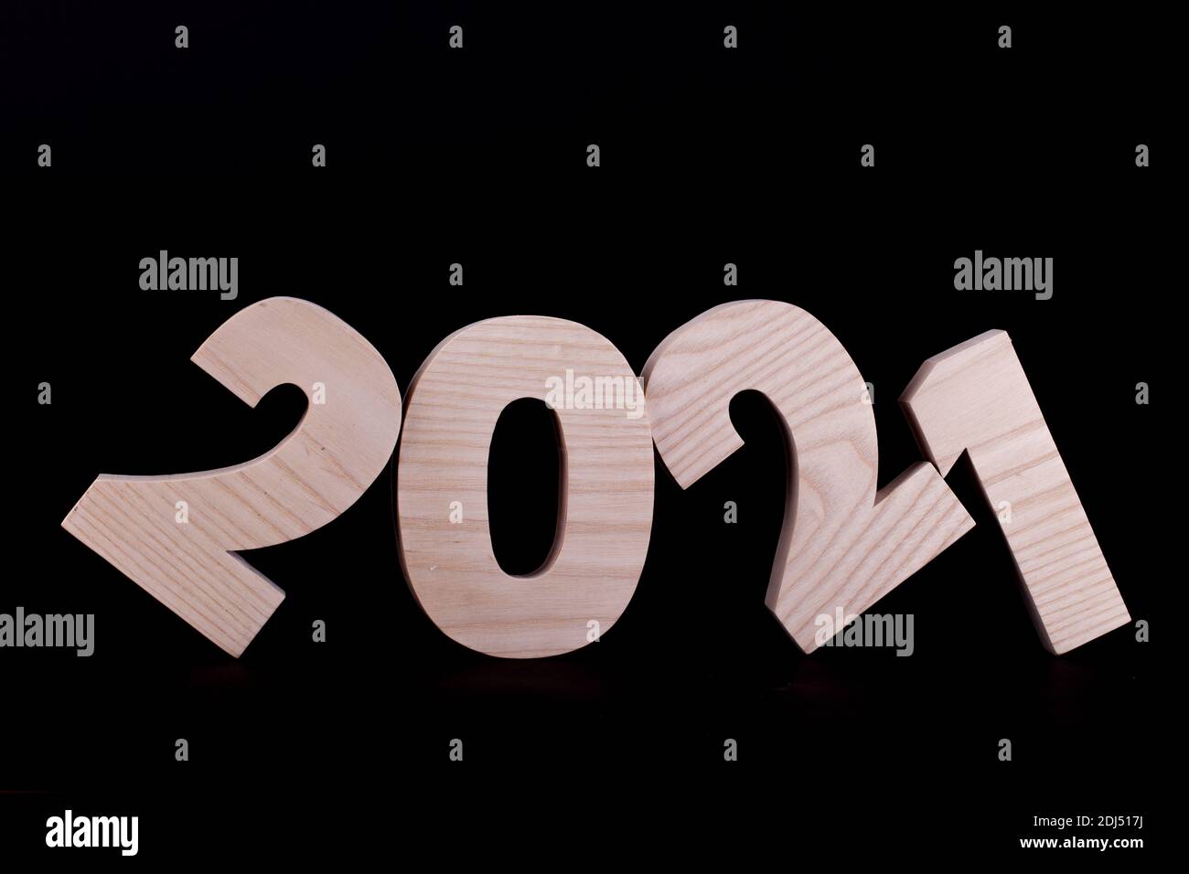 2021 year large wooden numbers tilted and leaning. Hardwood characters ...