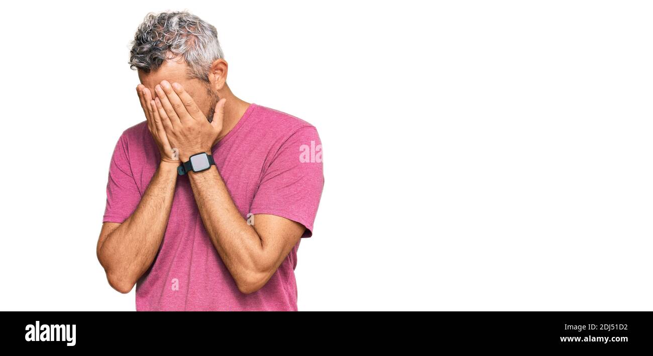 Middle age grey-haired man wearing casual clothes with sad expression ...