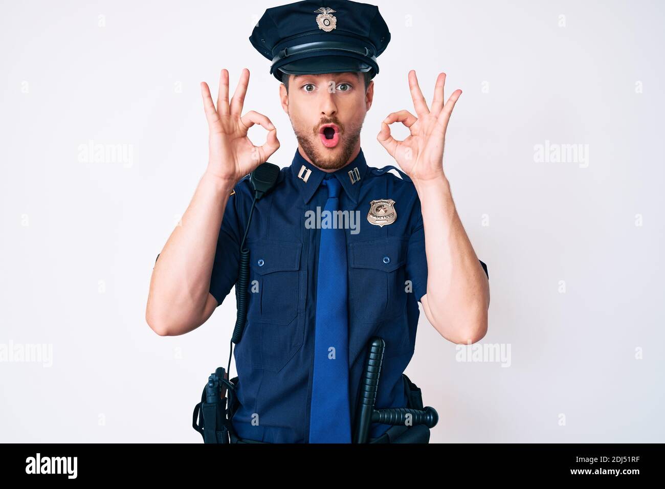 Young caucasian man wearing police uniform looking surprised and ...