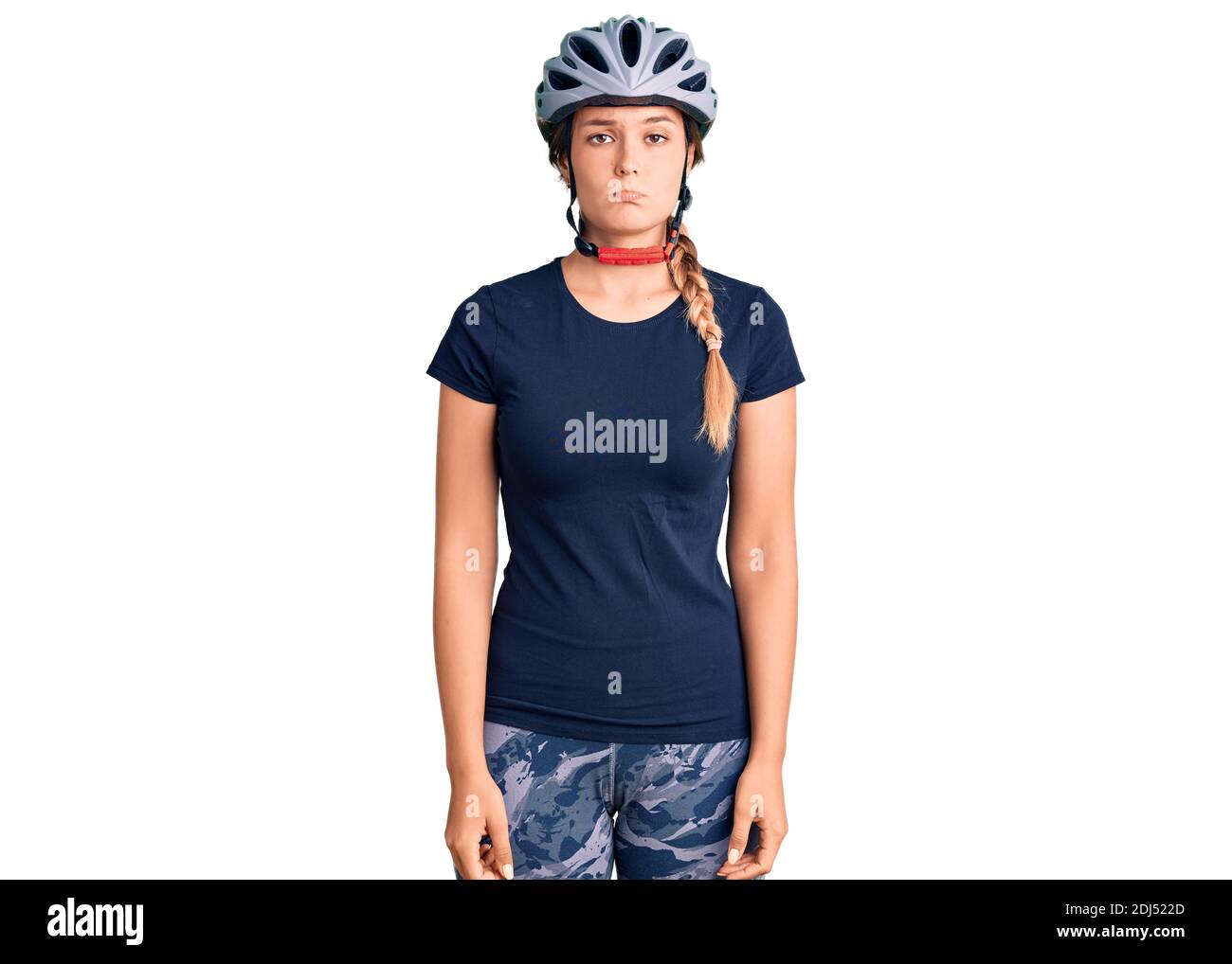 Beautiful caucasian woman wearing bike helmet depressed and worry for ...