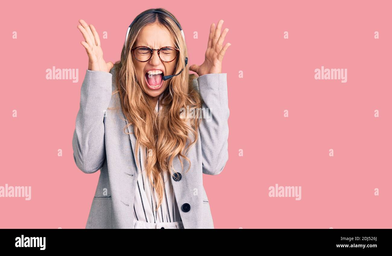 Young beautiful blonde woman wearing call center agent headset ...