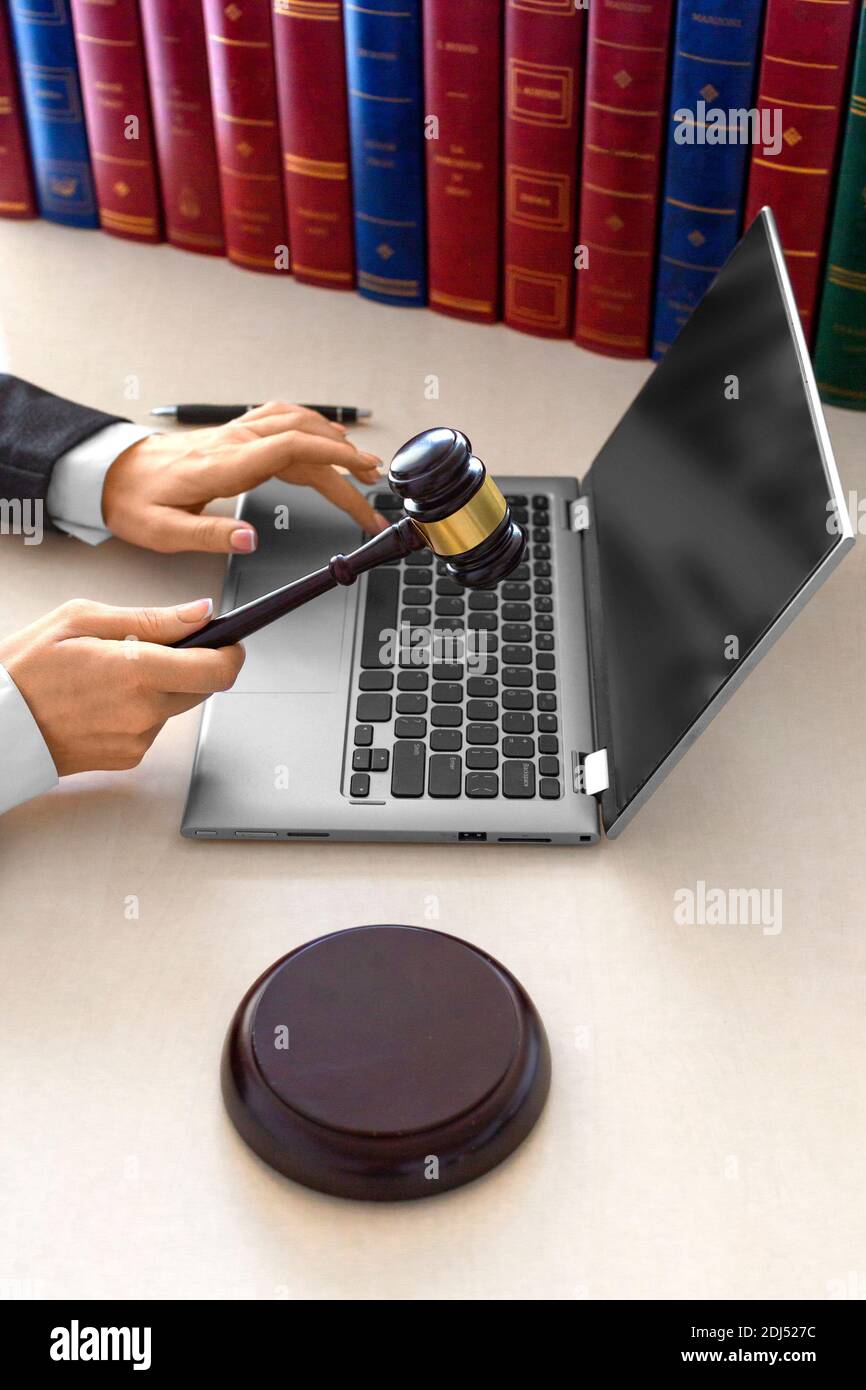 Online auction. Female hands with a gavel in the auctioneer's office ...
