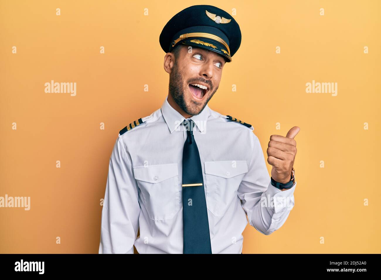 Handsome hispanic man wearing airplane pilot uniform smiling with happy ...