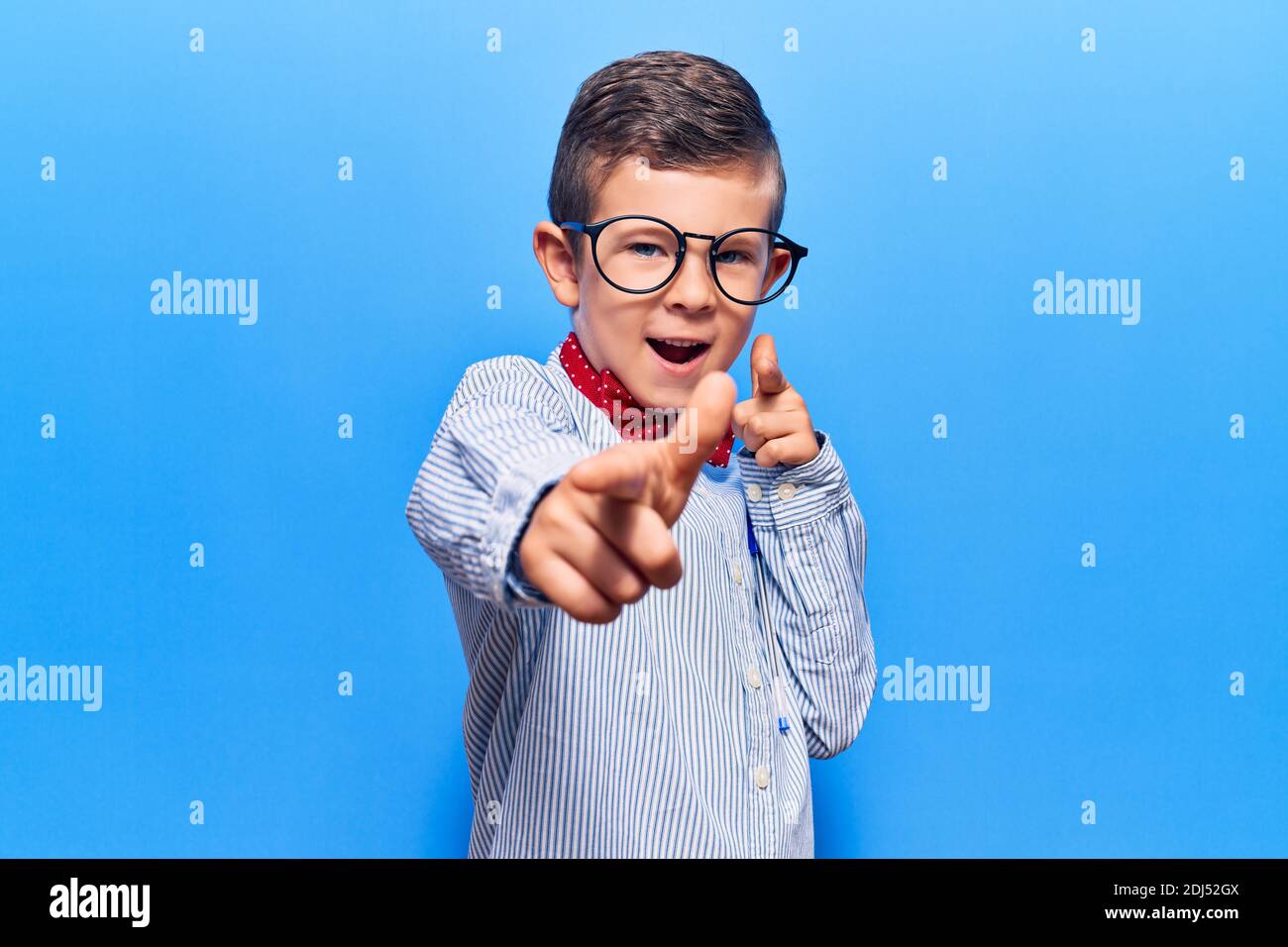 Cute blond kid wearing nerd bow tie and glasses pointing fingers to ...