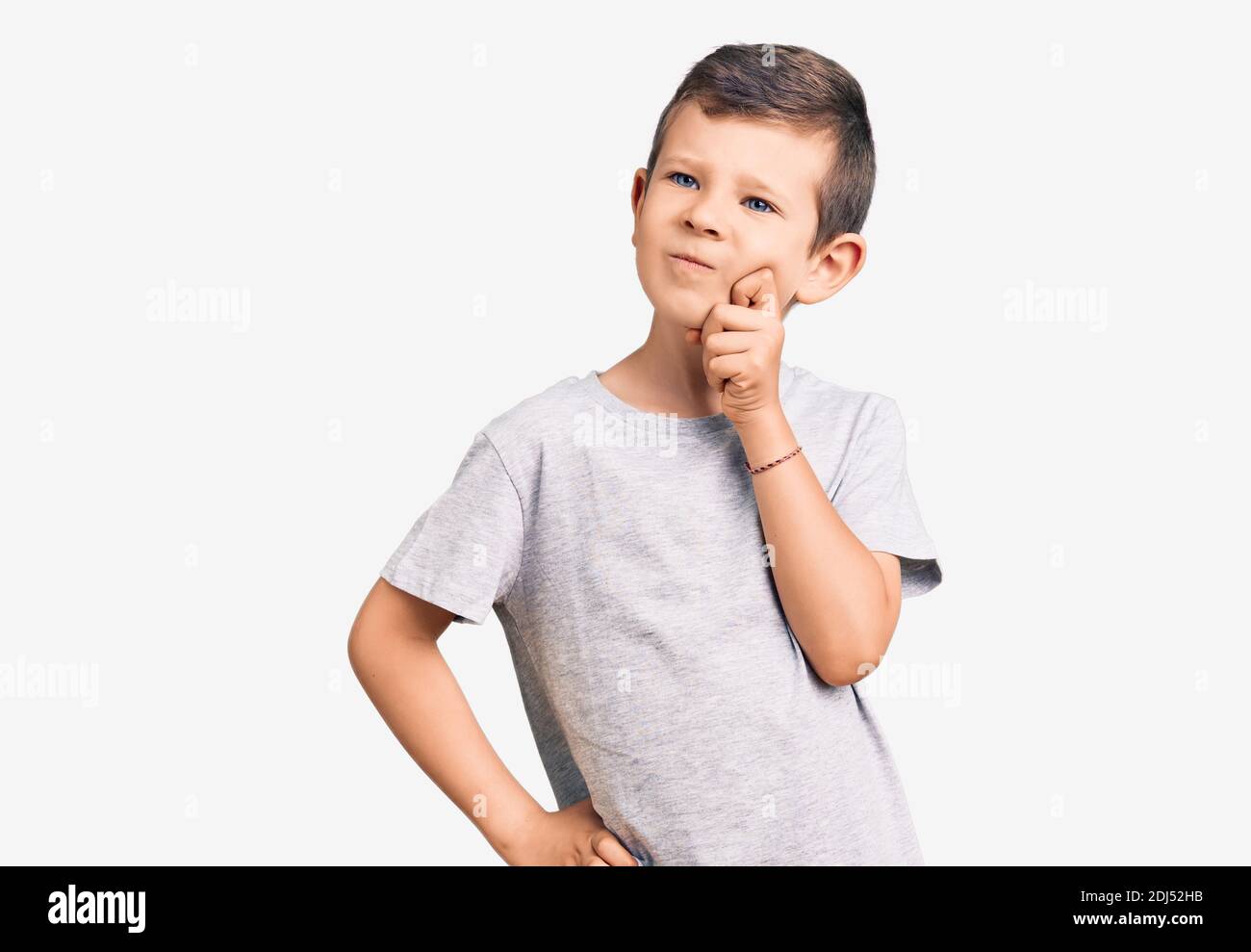 Cute blond kid wearing casual clothes serious face thinking about ...