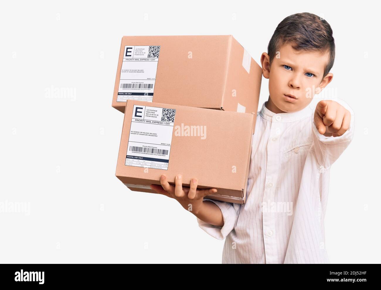 Cute blond kid holding delivery package pointing with finger to the ...