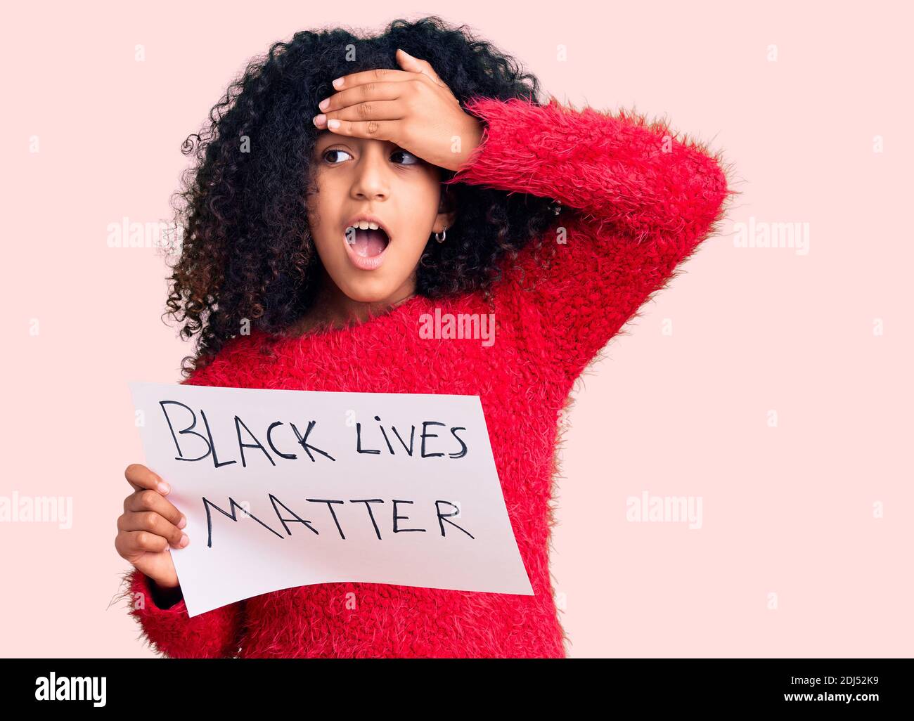 African american child with curly hair holding black lives matter ...