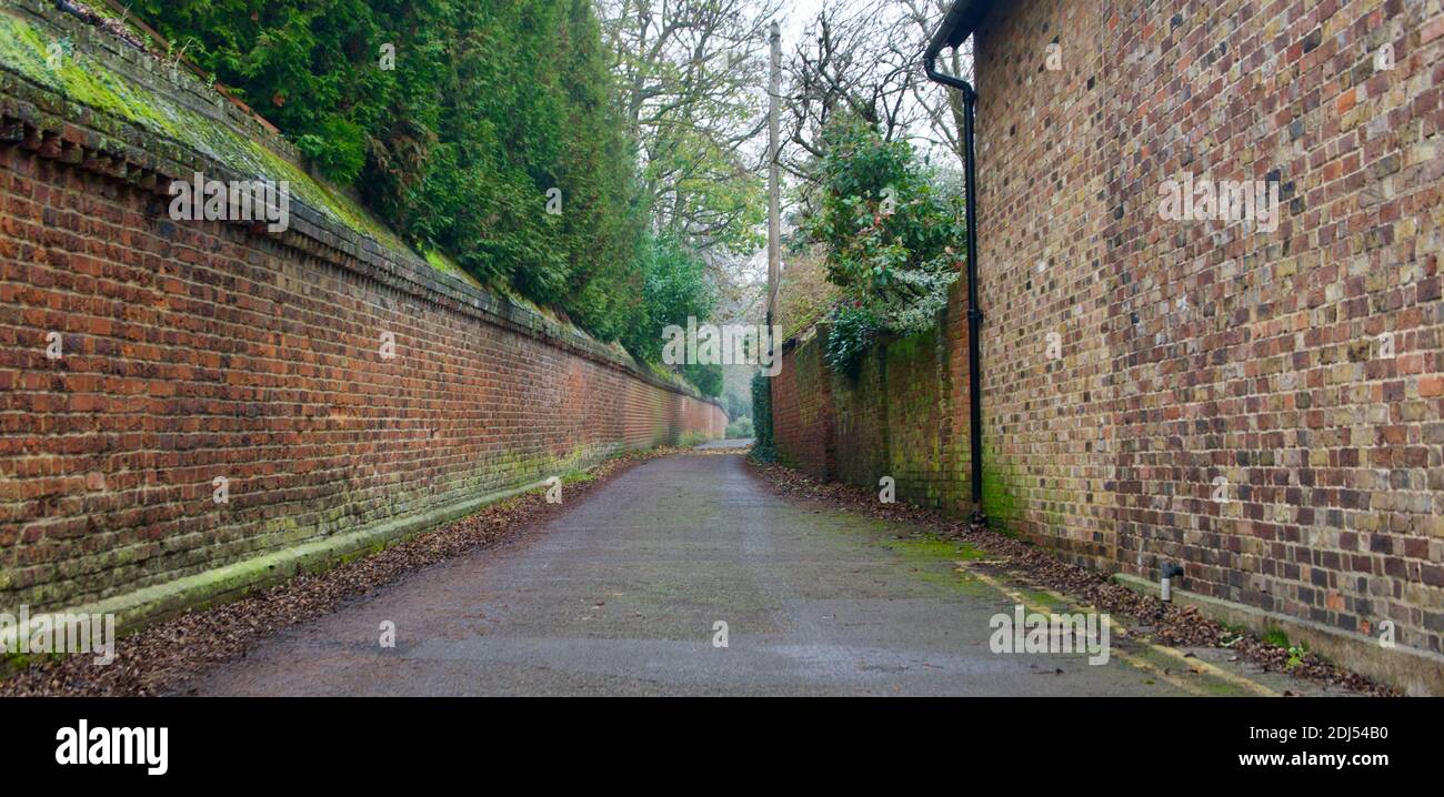 Village street scene taken in wide angle showing ancient brick walls ...