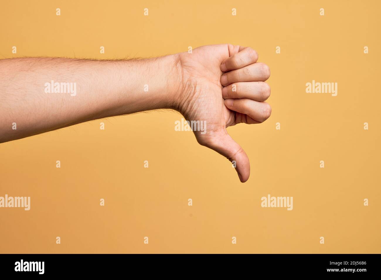 Hand of caucasian young man showing fingers over isolated yellow ...