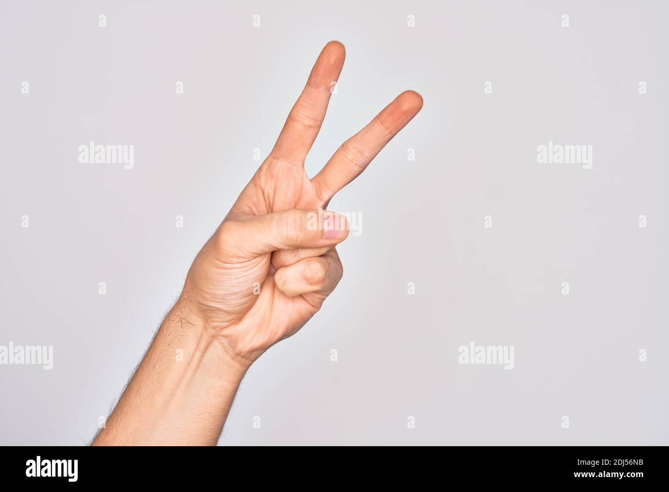 Hand of caucasian young man showing fingers over isolated white ...