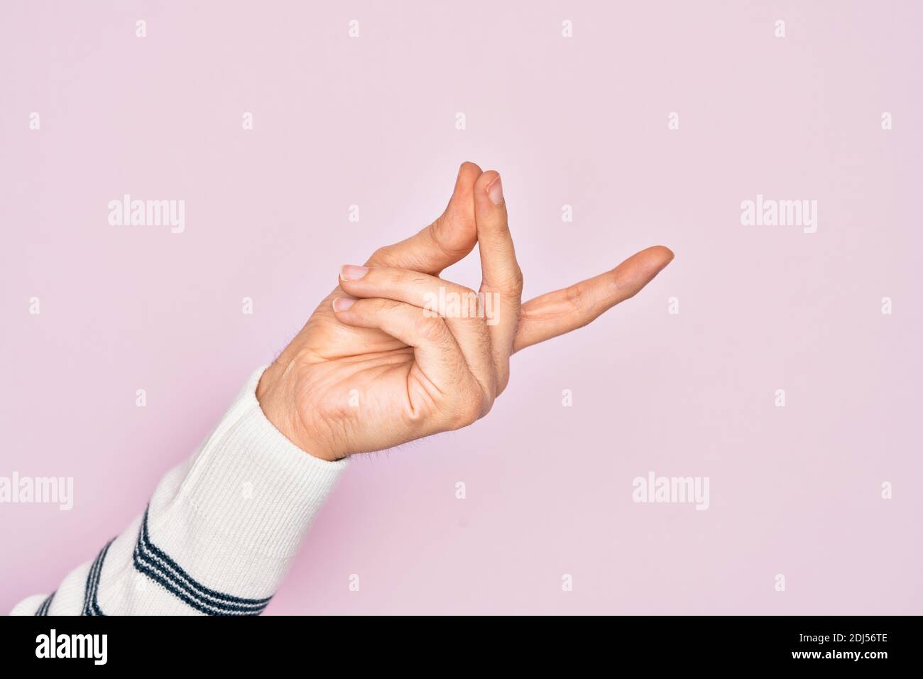 Hand of caucasian young man showing fingers over isolated pink ...