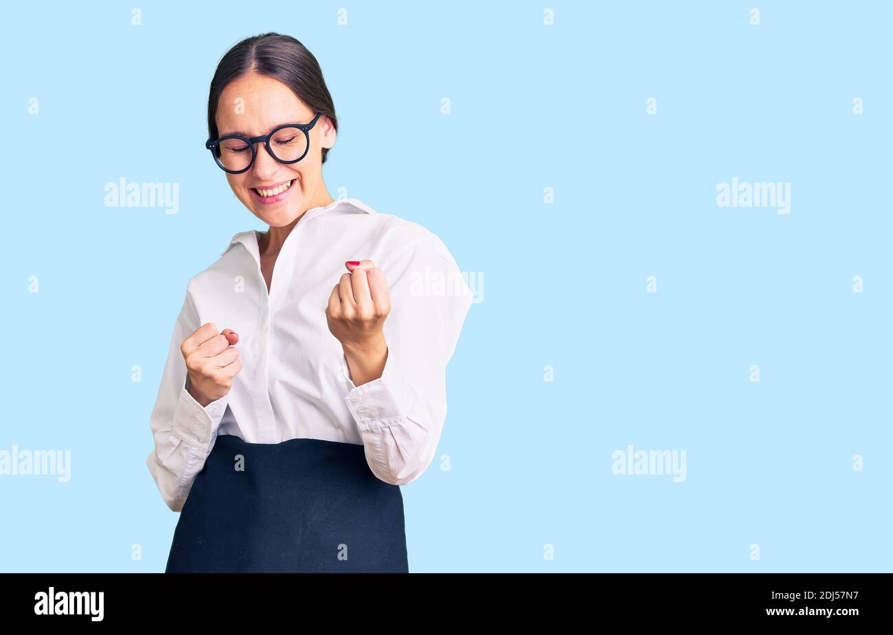 Beautiful brunette young woman wearing professional waitress apron ...