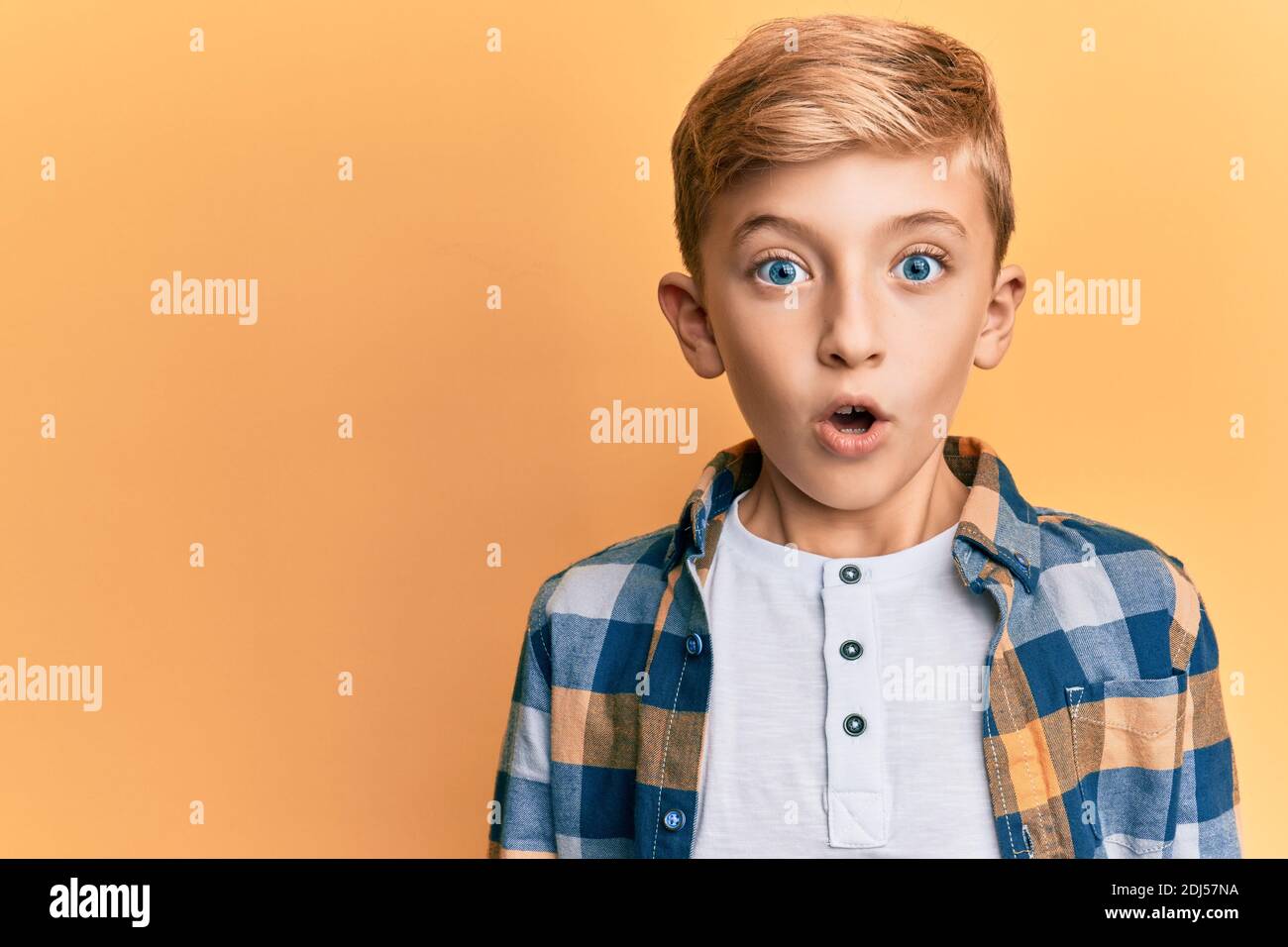 Little caucasian boy kid wearing casual clothes scared and amazed with ...