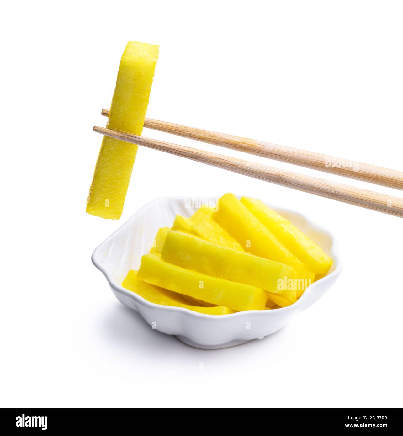 Marinated daikon slice picked up with chopsticks isolated on white ...