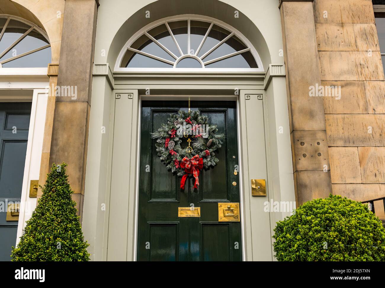 Decorative Christmas wreath on panelled front door of Georgian ...