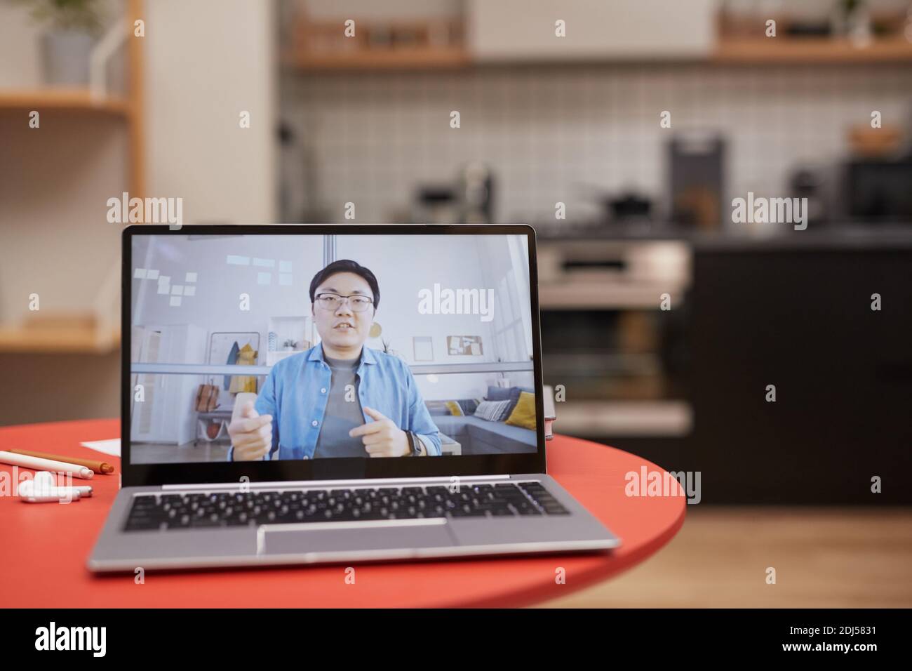 Background image of laptop with Asian man speaking on screen, online ...
