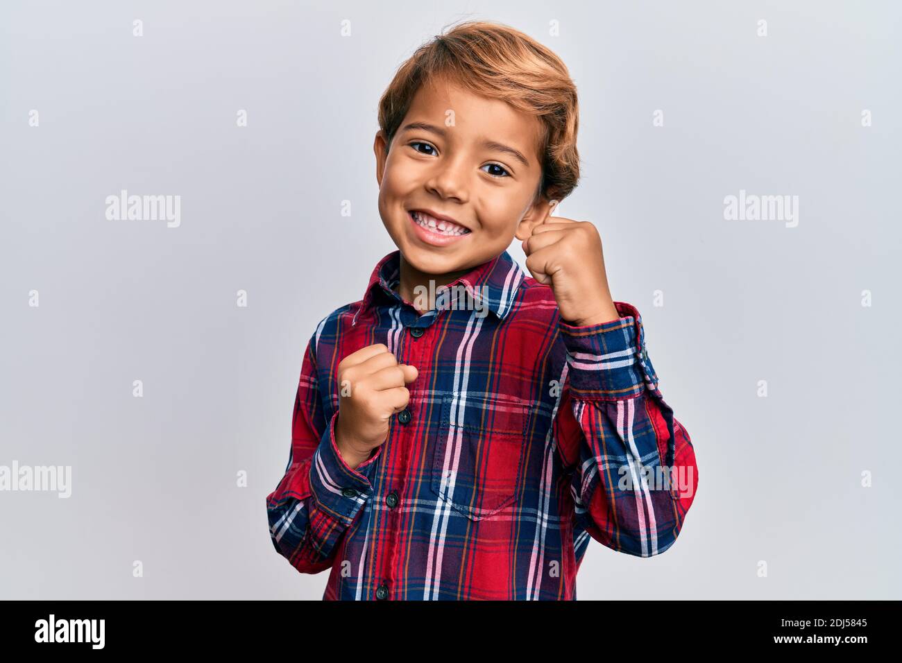 Adorable latin kid wearing casual clothes celebrating surprised and ...